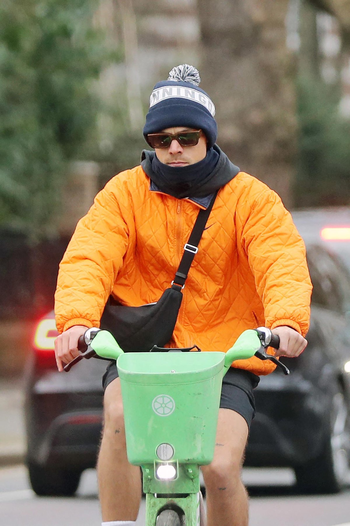 Harry Styles Rocks Neon Orange Jacket on Birthday Bike Ride | Us Weekly