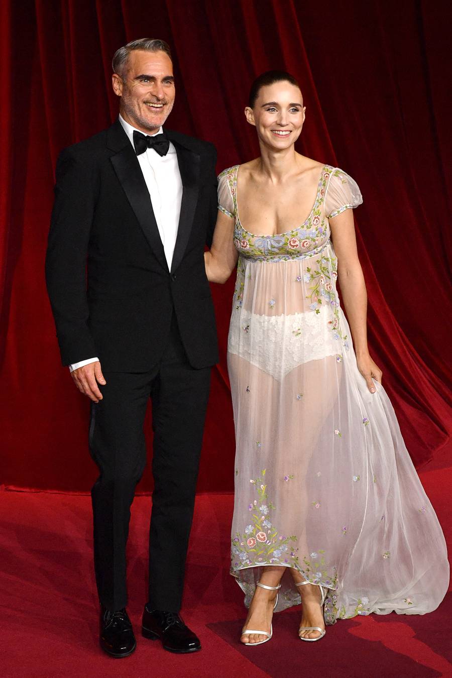 Joaquin Phoenix Fixes Rooney Maras Train At Academy Gala Us Weekly