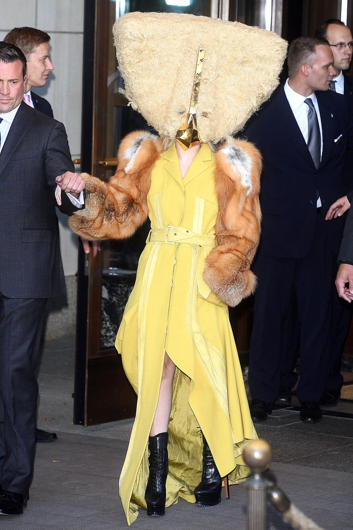 Lady Gaga Dresses Like a Chicken in Giant Furry Mask, Yellow Dress